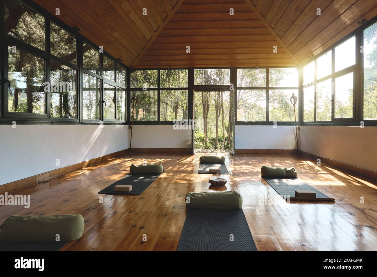 Gym studio for yoga meditation practices background with mats on wooden ...