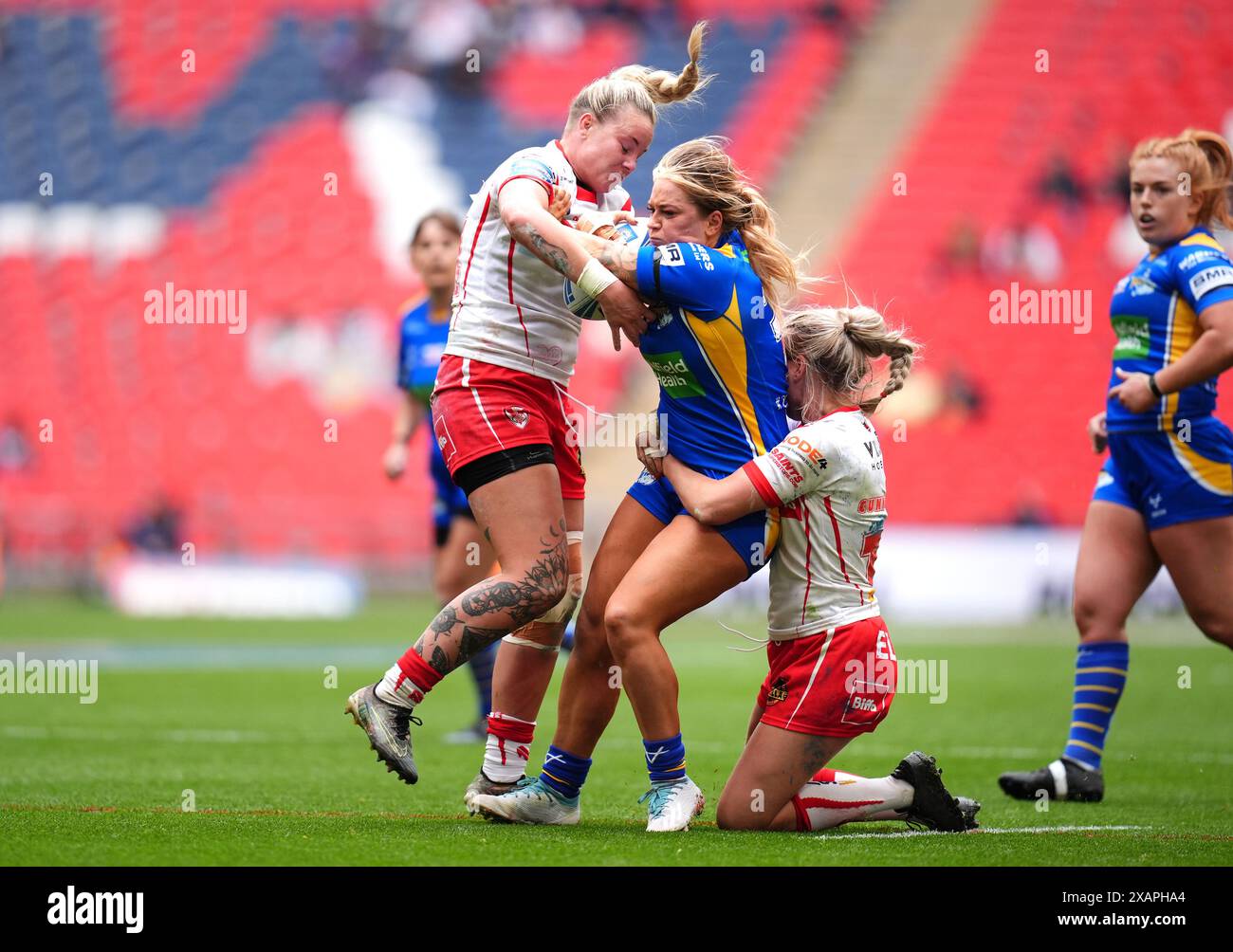 Leeds Rhinos' Shona Hoyle (centre) is tackled by St Helens' Naomi ...