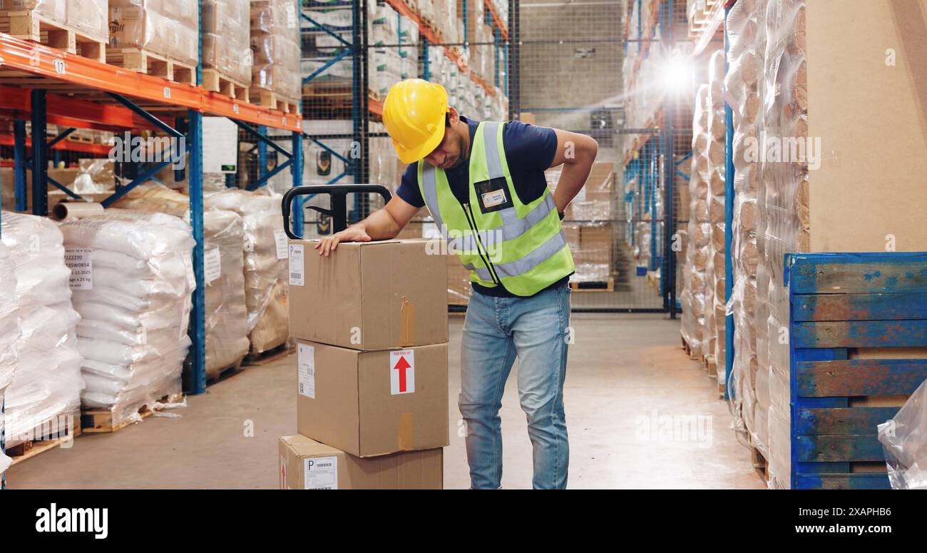 Back pain, man and boxes in warehouse for injury, overworked and strain ...