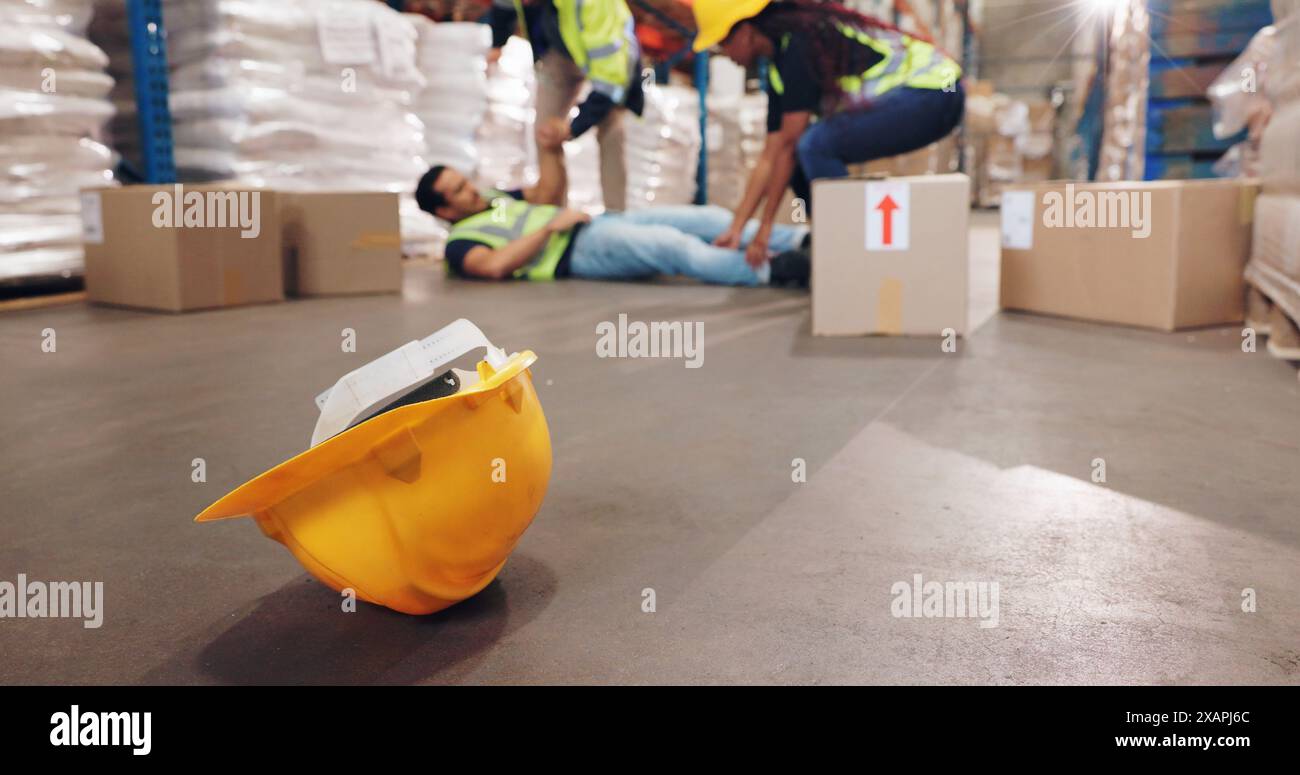 Accident, fall and helmet with man in warehouse for delivery ...