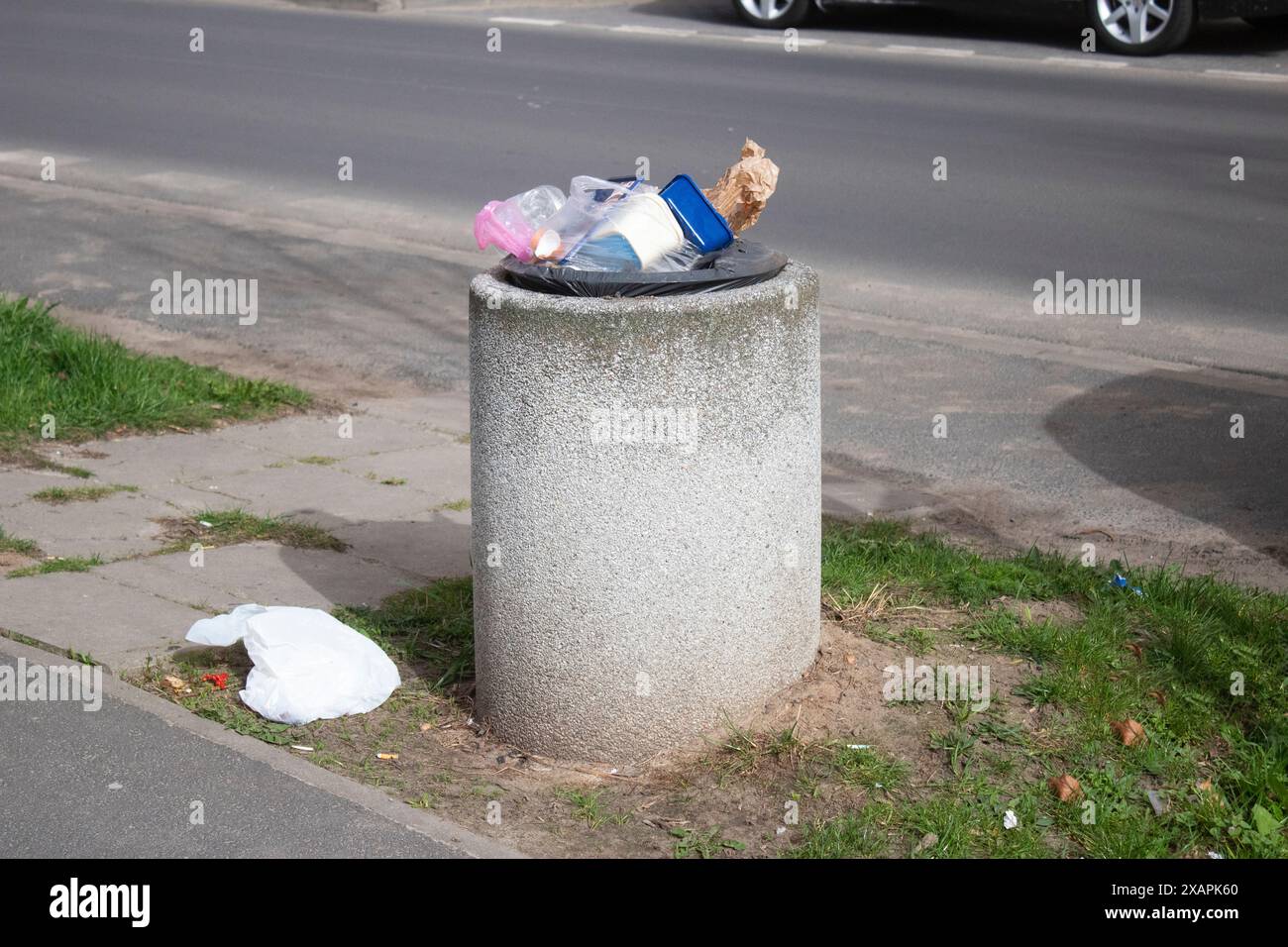 Public trash can on a city street filled with garbage Stock Photo - Alamy