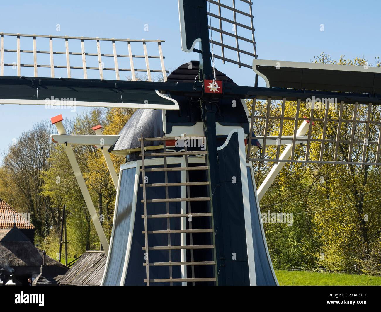 Close-up of a windmill showing the wooden blades and structural details ...