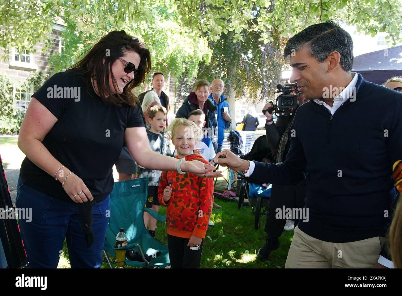 Prime Minister Rishi Sunak pays a pound to play 'Splat the Rat' at a ...