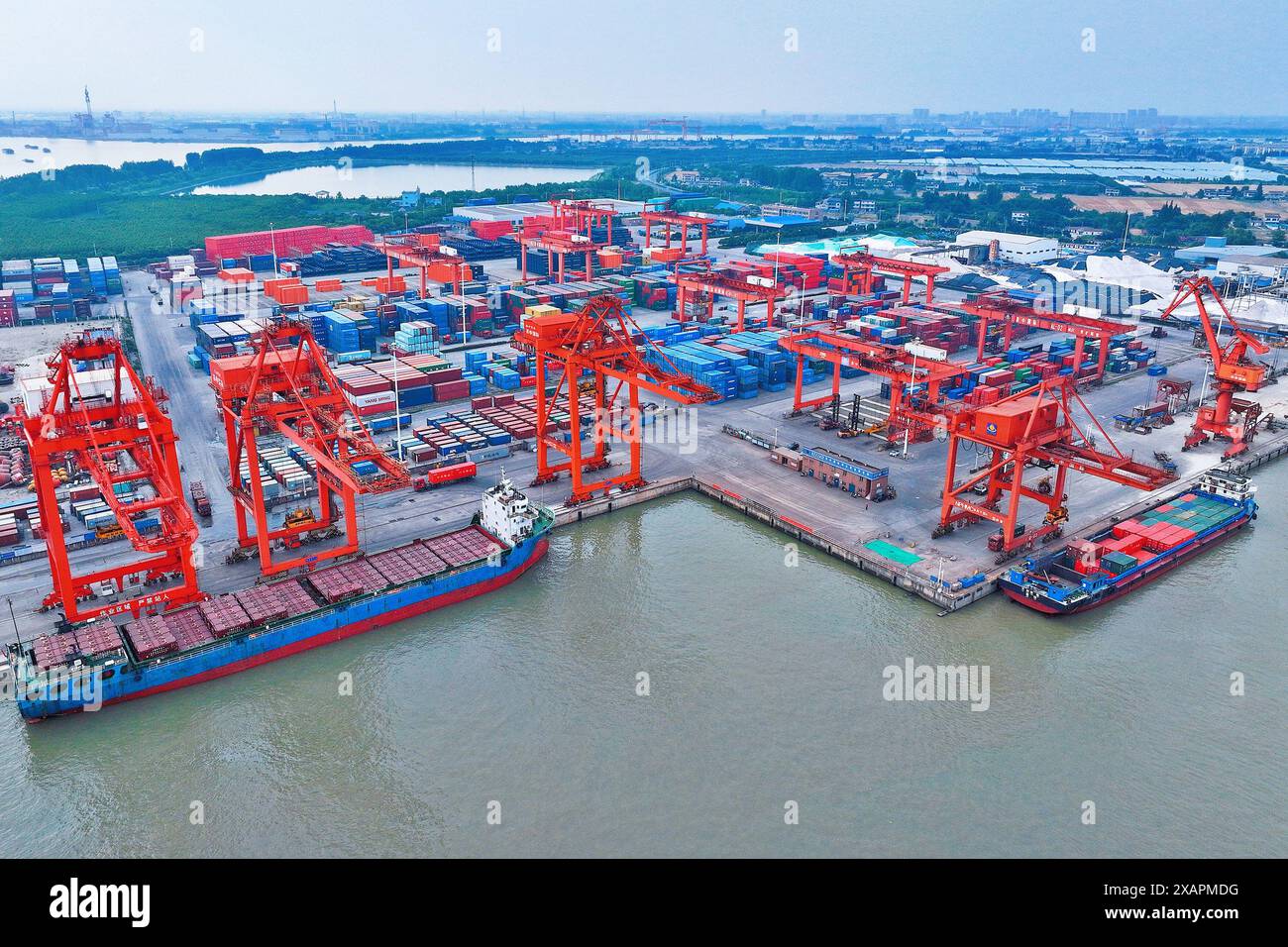 RUGAO, CHINA - JUNE 8, 2024 - Cargo ships work at the berth of Suzhong ...