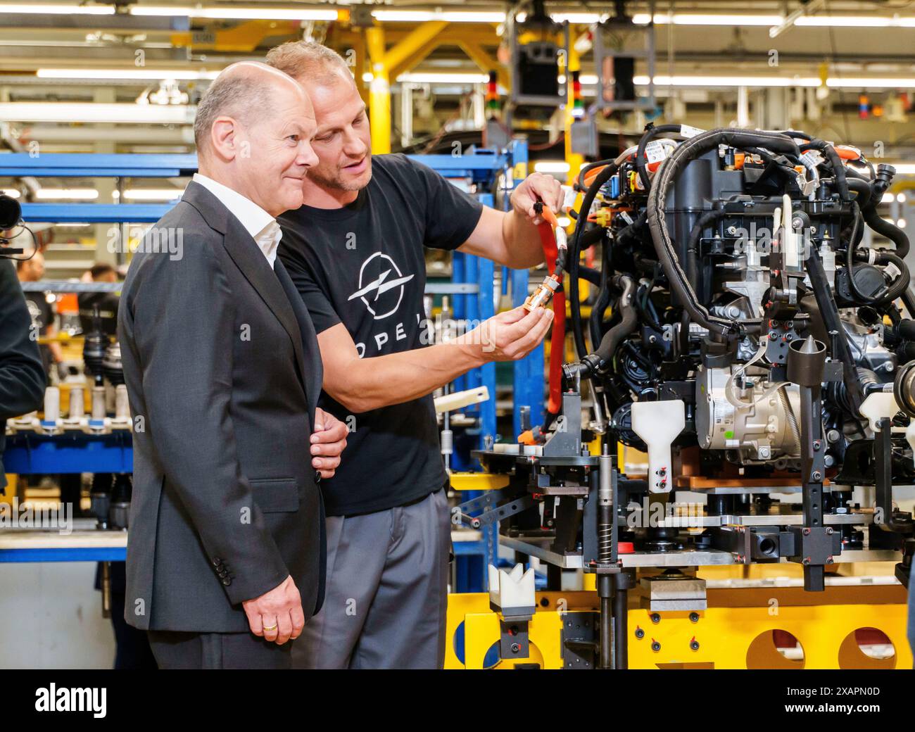08 June 2024, Hesse, Rüsselsheim: German Chancellor Olaf Scholz (SPD, l ...