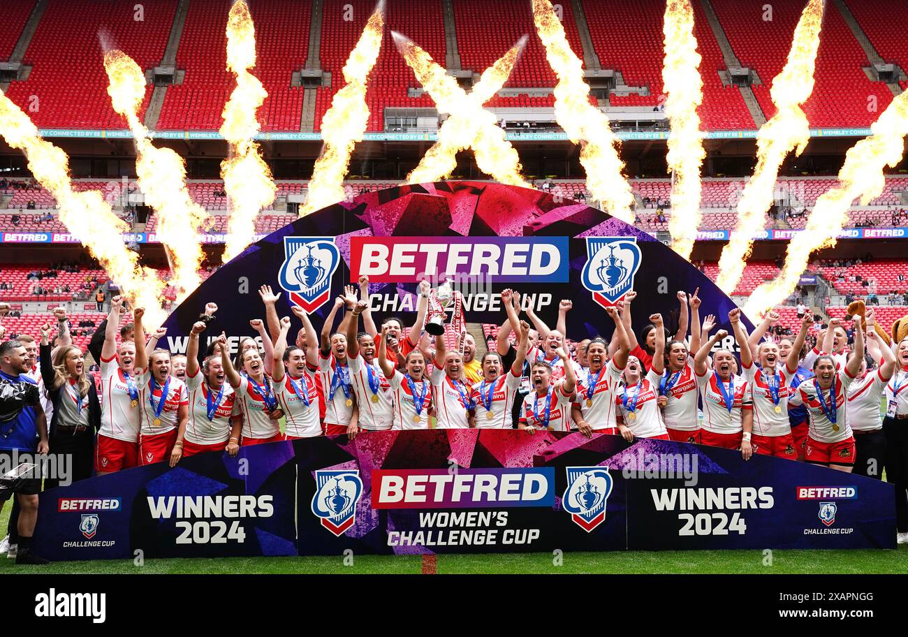 The St Helens players lift the trophy as pyrotechnics go off after ...
