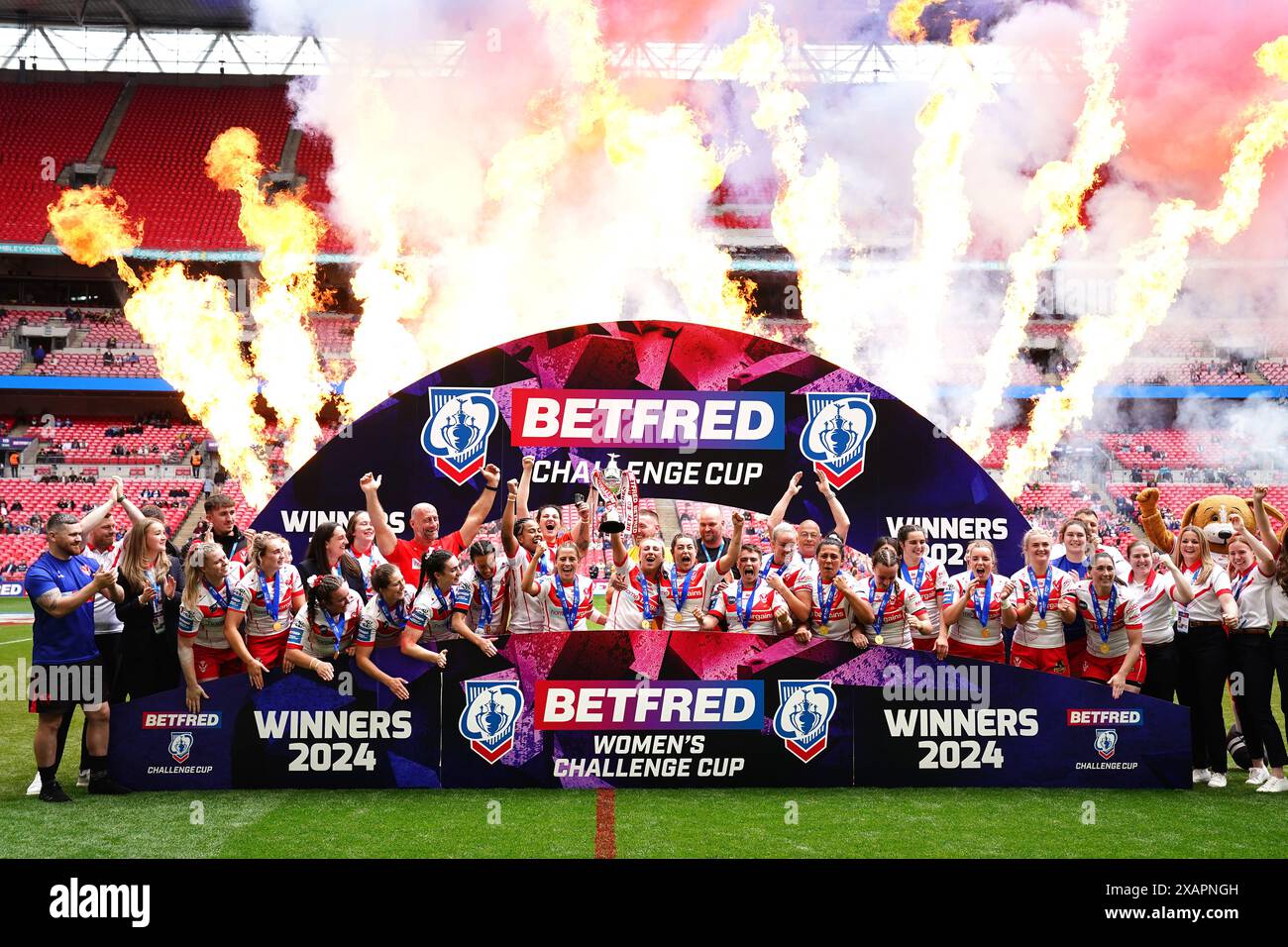 The St Helens players lift the trophy as pyrotechnics go off after ...