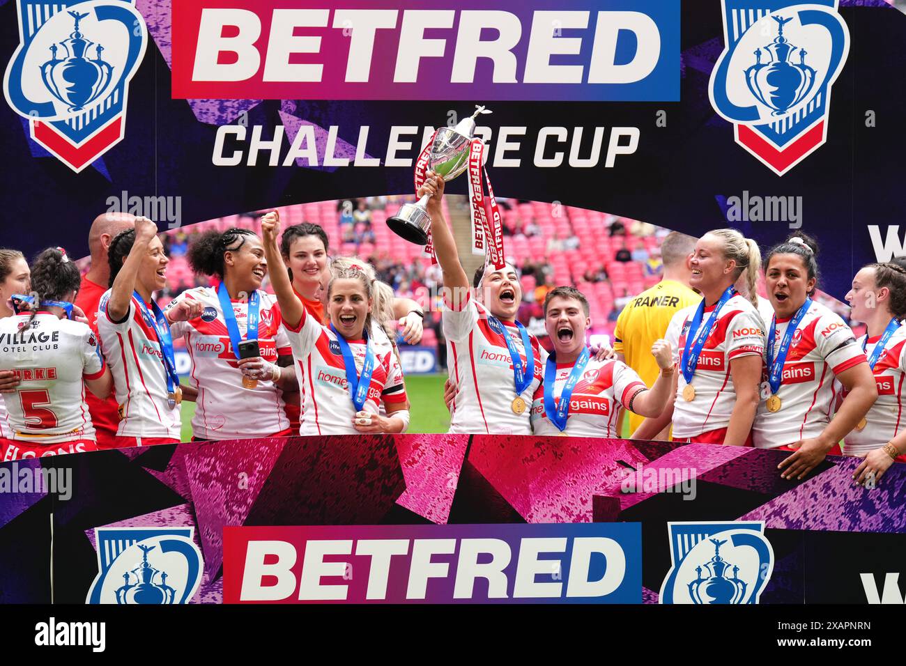 St Helens' Emily Rudge (centre) celebrates with the trophy and team ...