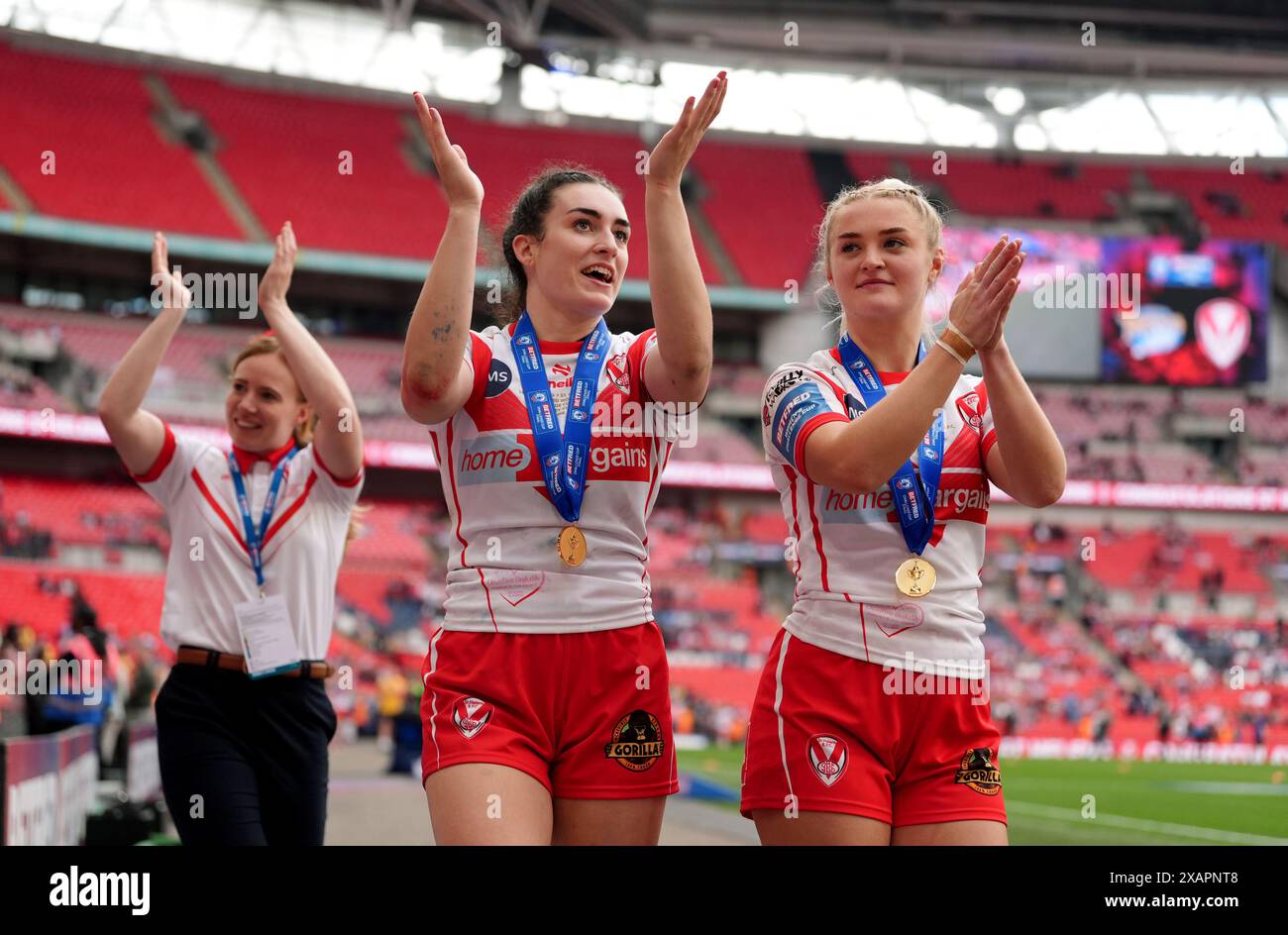St Helens' Leah Burke (centre) and Erin Stott (right) celebrate after ...