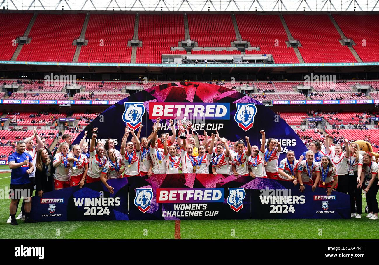 The St Helens players lift the trophy after victory in the Betfred ...