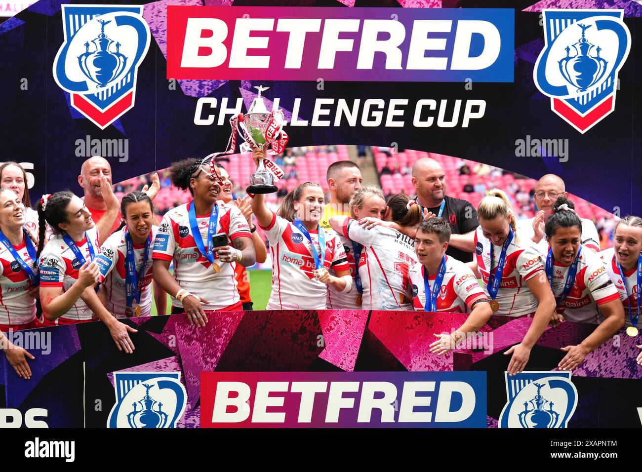 The St Helens players lift the trophy after victory in the Betfred ...
