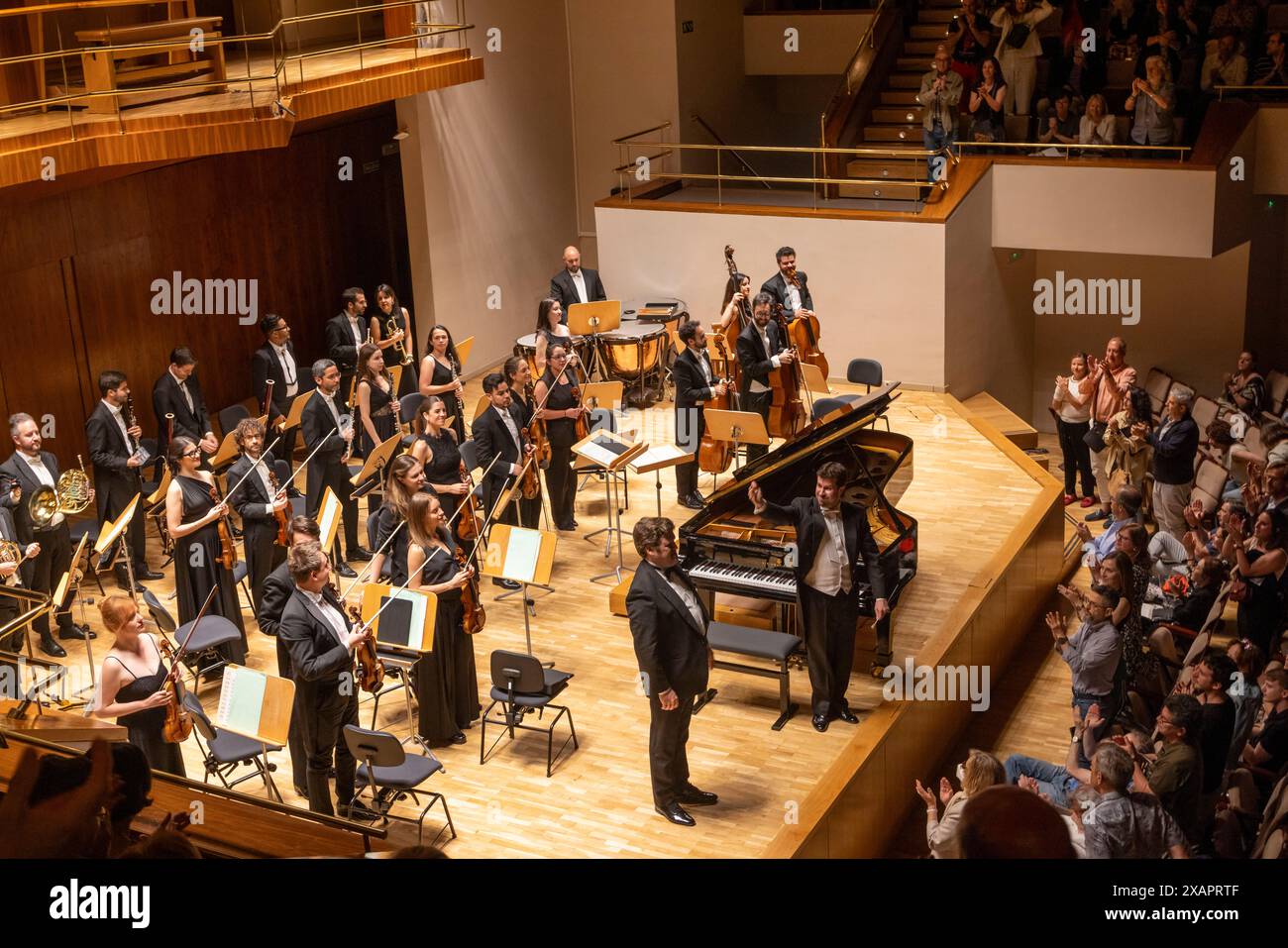 conductor acknowledging soloist while receiving applause, National ...