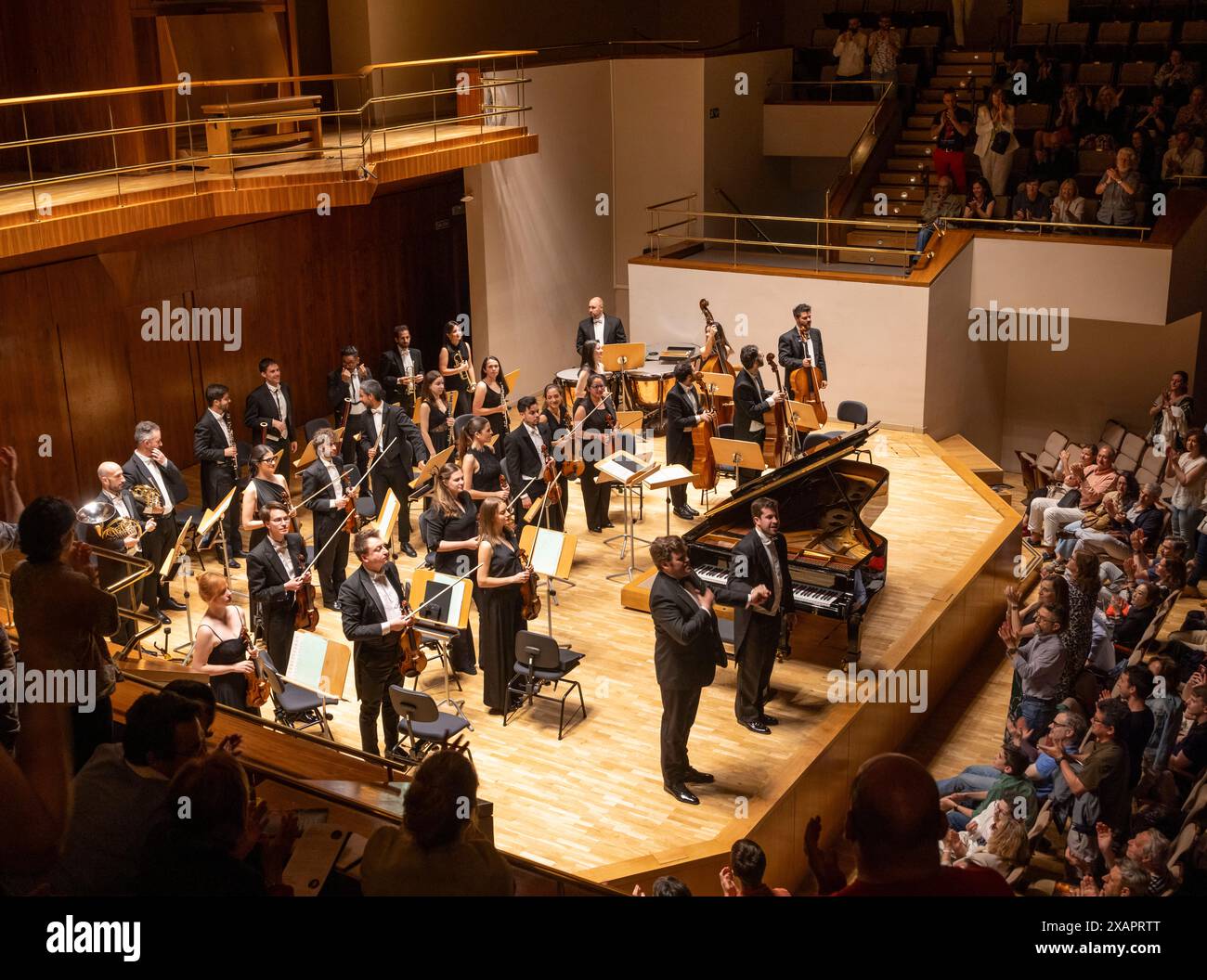 soloist and conductor holding hands while receiving applause, National ...