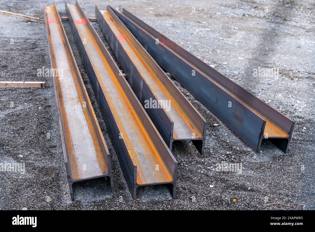 Several double t beams lying on the ground in the sand of a ...