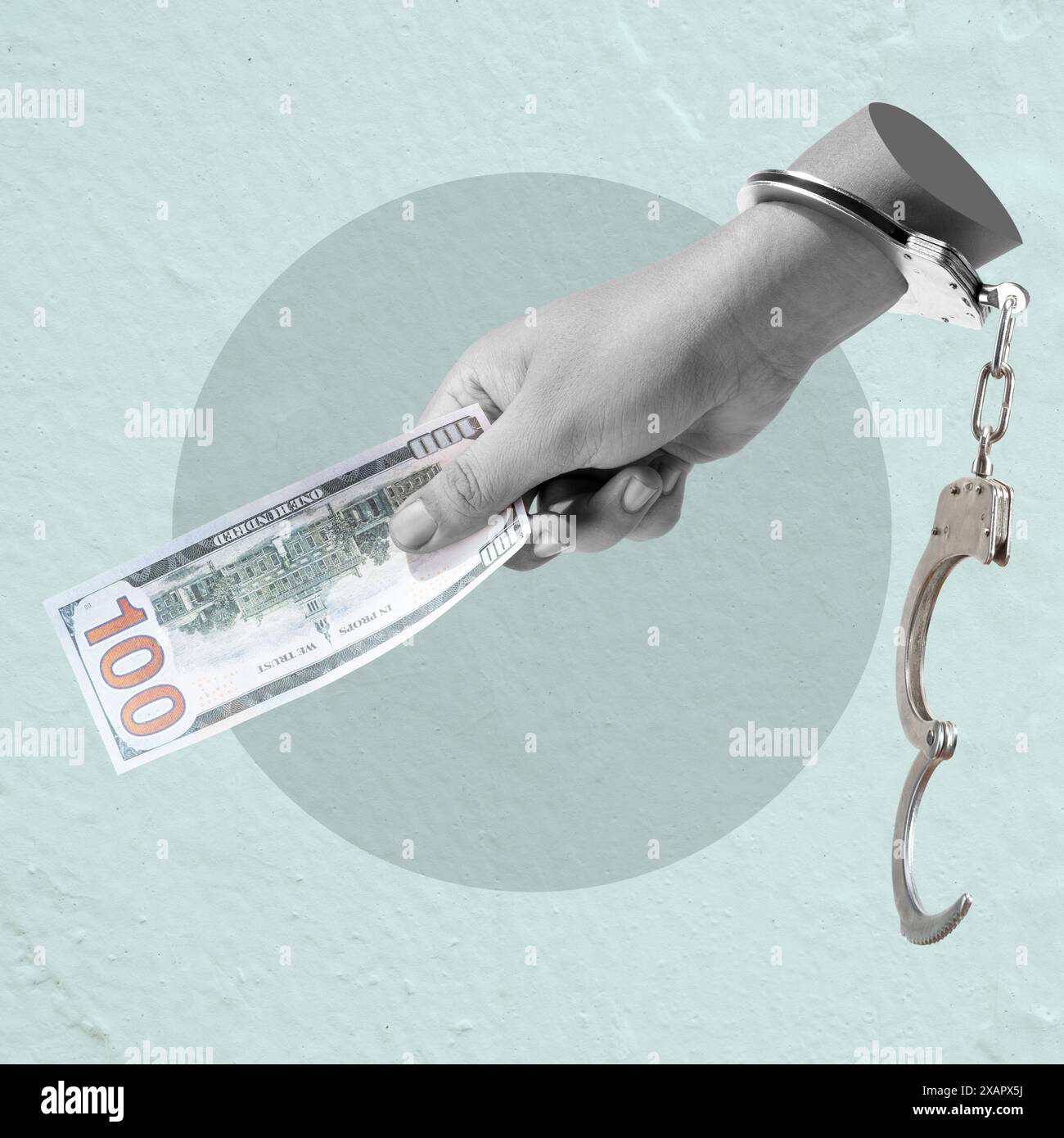 A human hand with a handcuff holding one hundred dollar banknote money ...