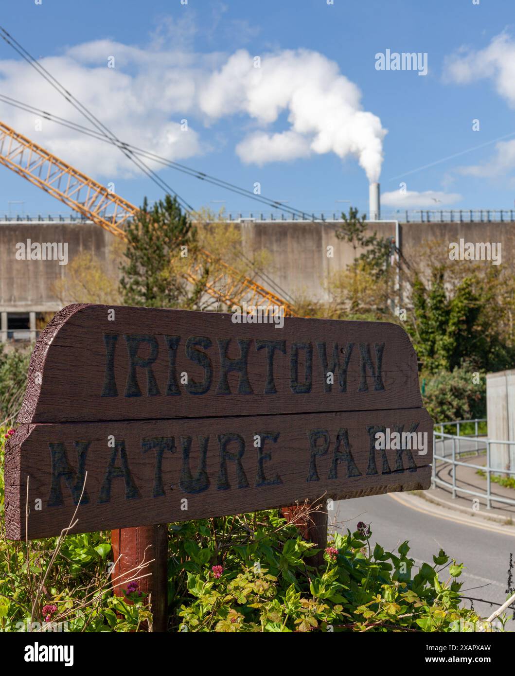 Wooden sign for Irishtown Nature Park with a concrete industrial ...