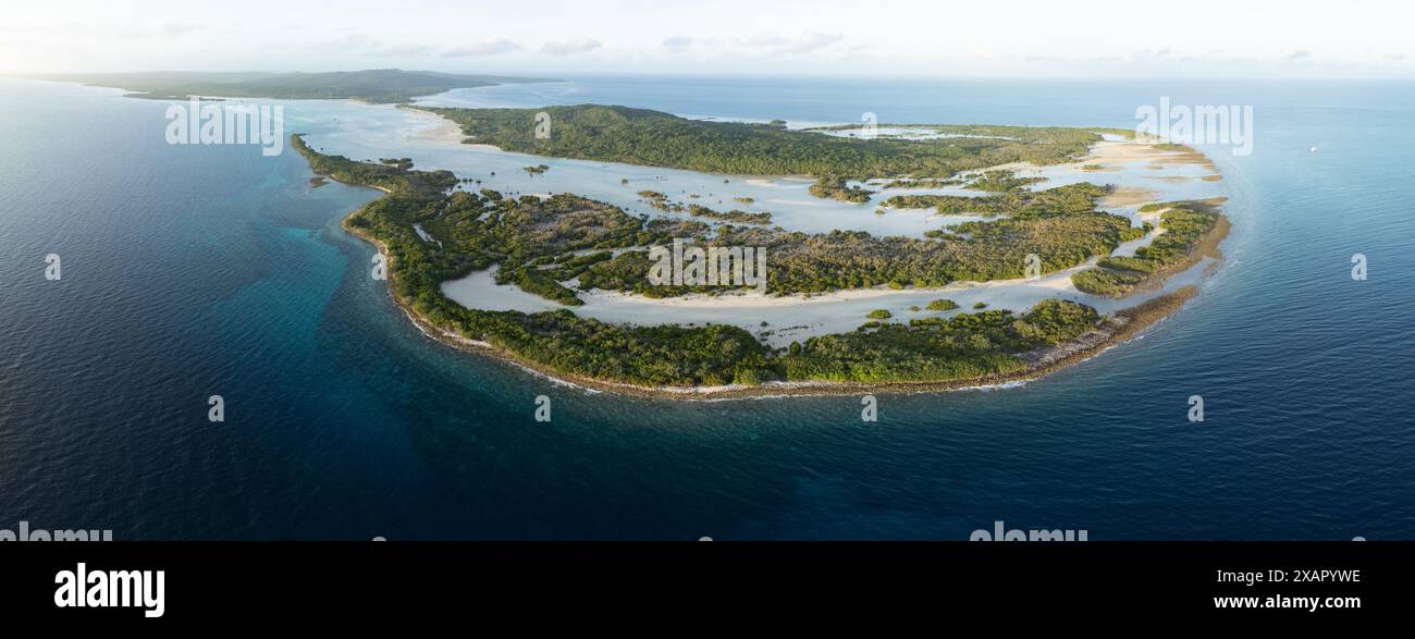 A diverse coral reef fringes a scenic and remote island, Pulau Selu, in ...