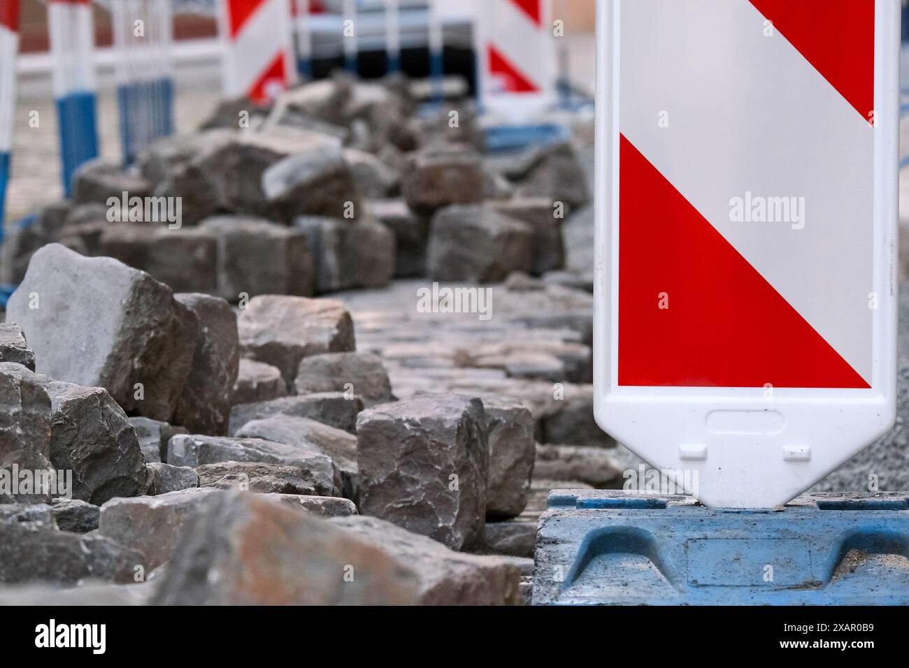 road markings around pavement work, a pile of cobblestones Stock Photo ...