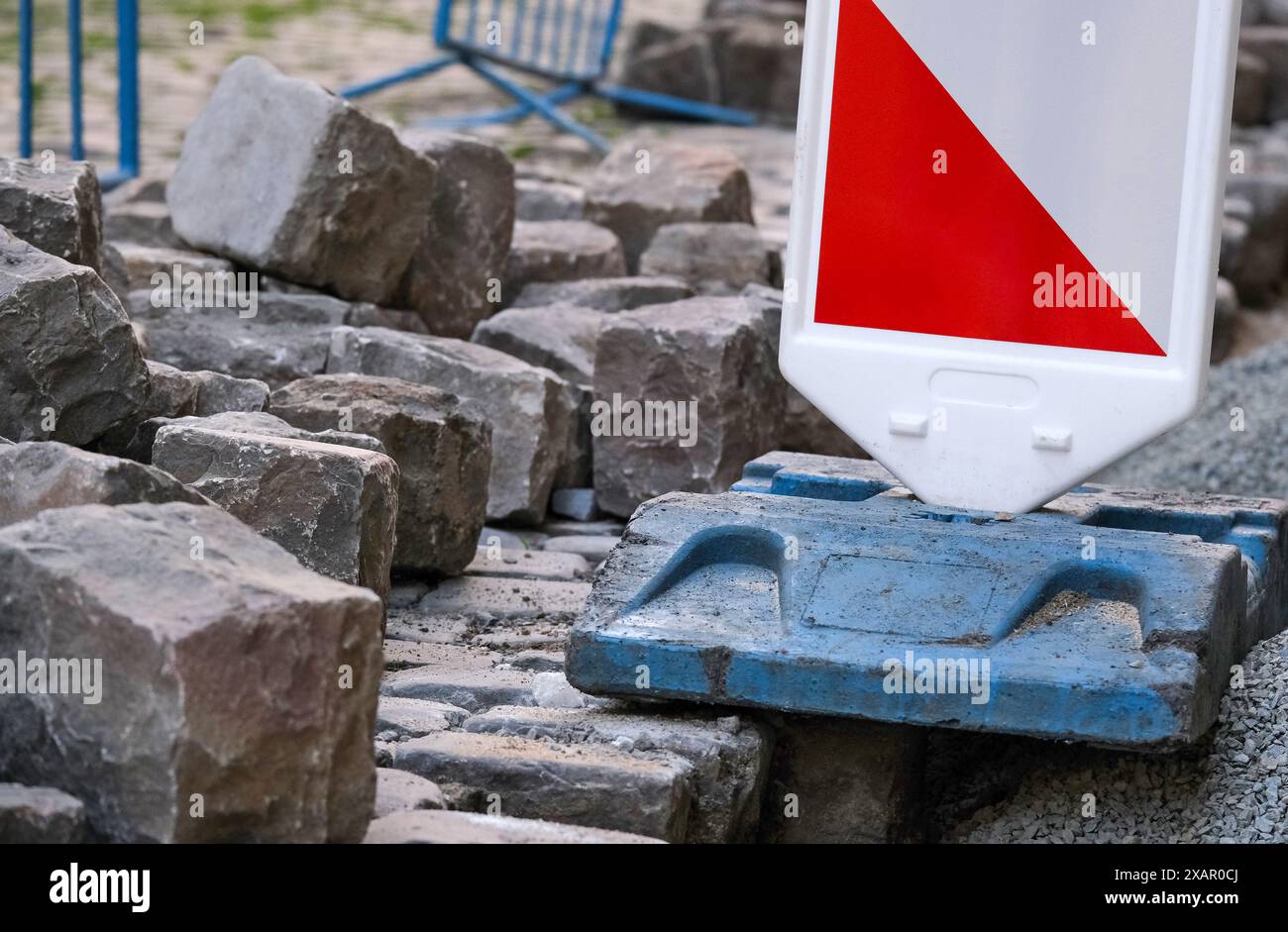 road markings around pavement work, a pile of cobblestones Stock Photo ...
