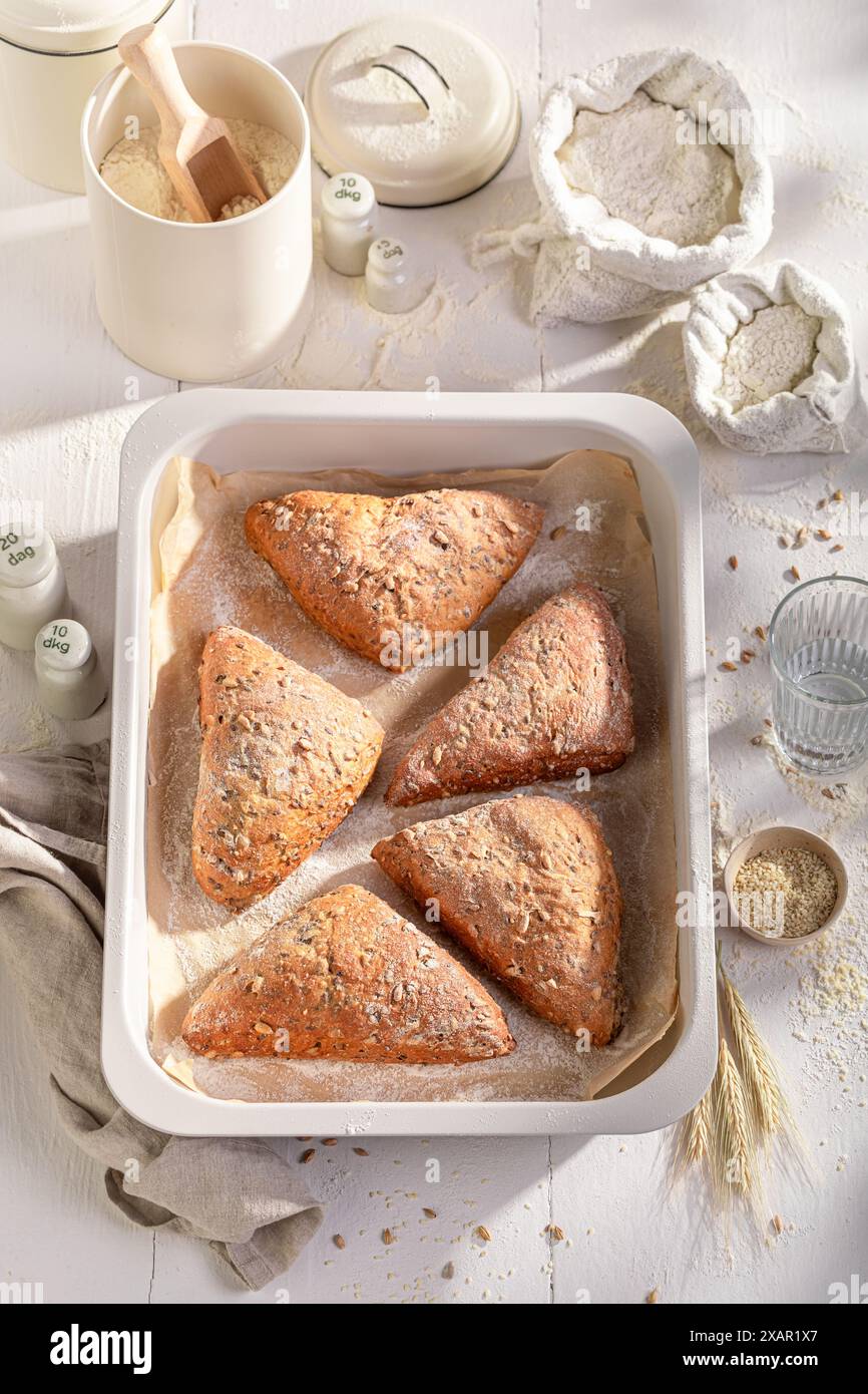 Brown and tasty triangular buns in rustic bakehouse. Triangular rolls ...