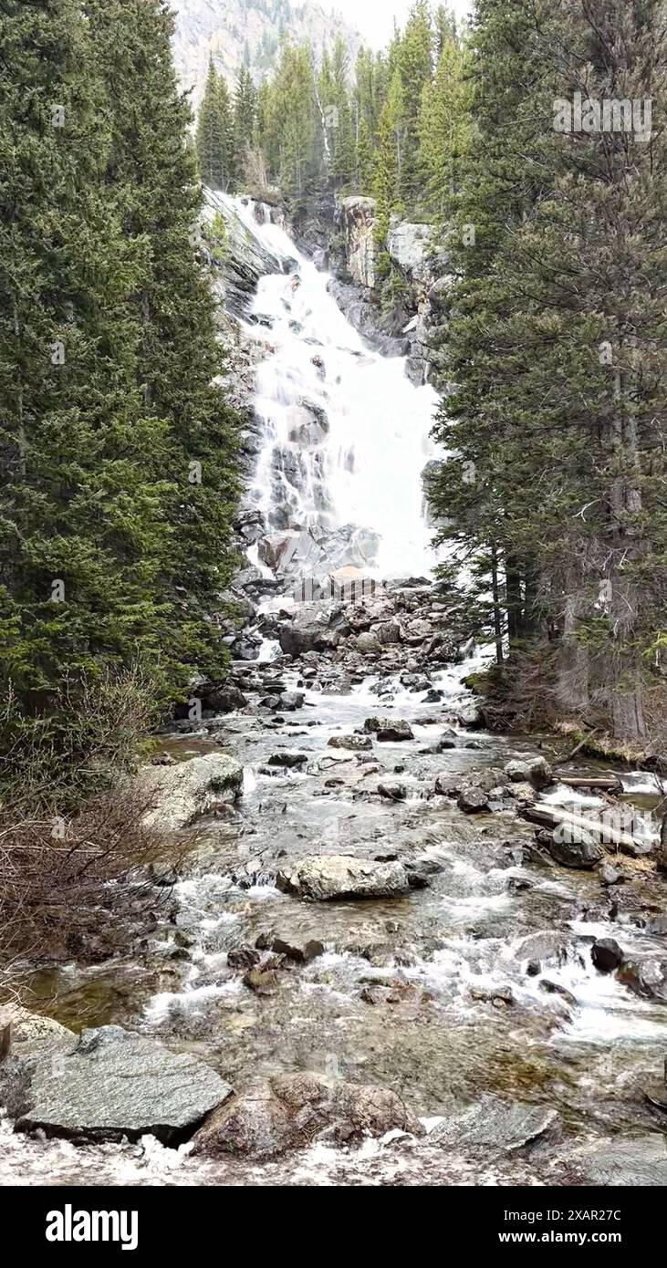 Hidden waterfalls during hike at Jenny lake trail in Mt. Teton National park in Wyoming, USA ...