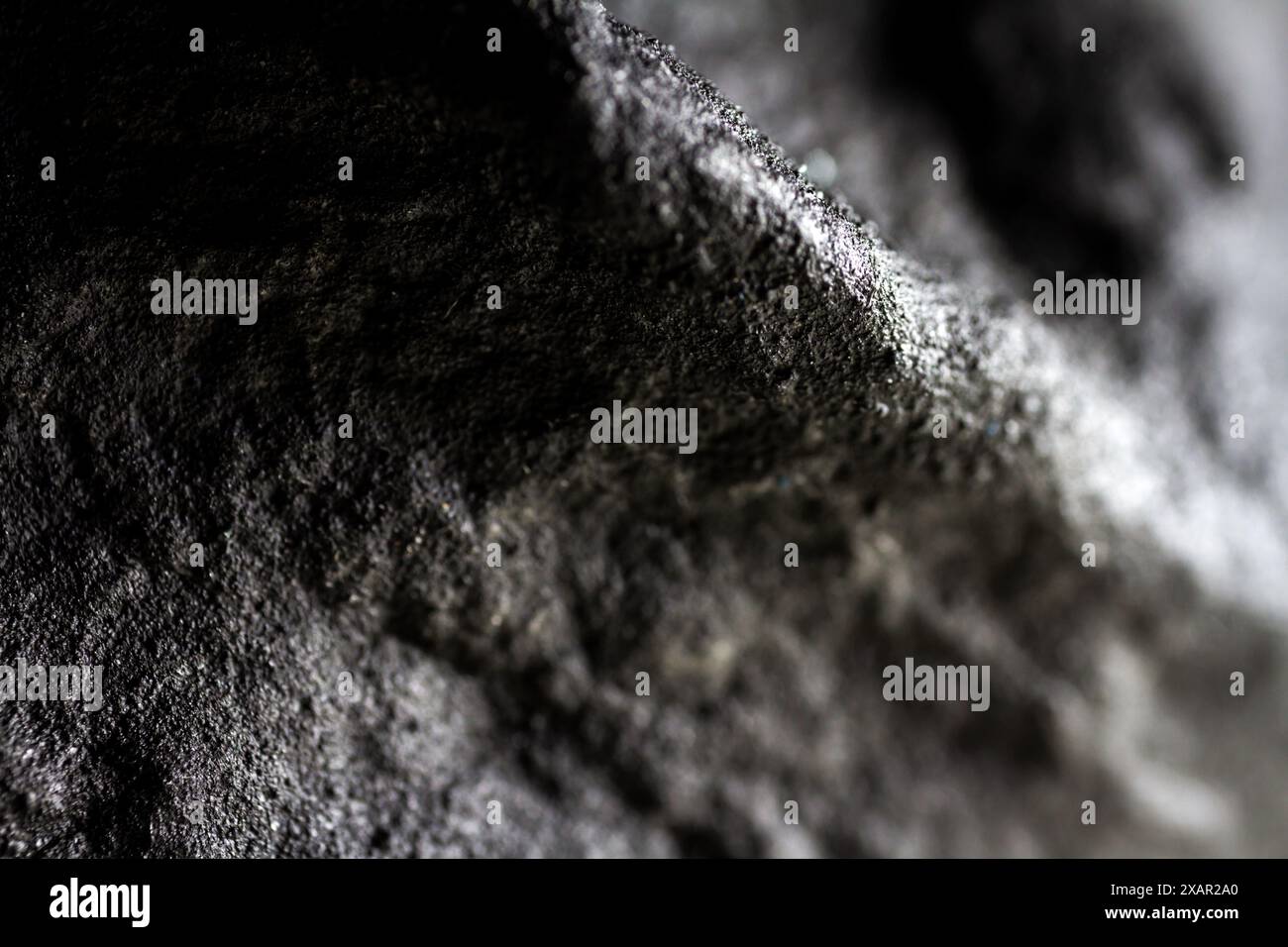 Extreme close up of painted in black handmade paper mache with a ...