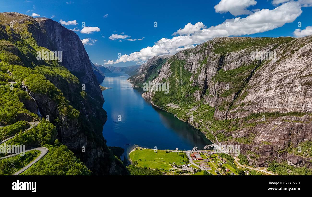 A winding road carves its way through towering mountains in Norway ...