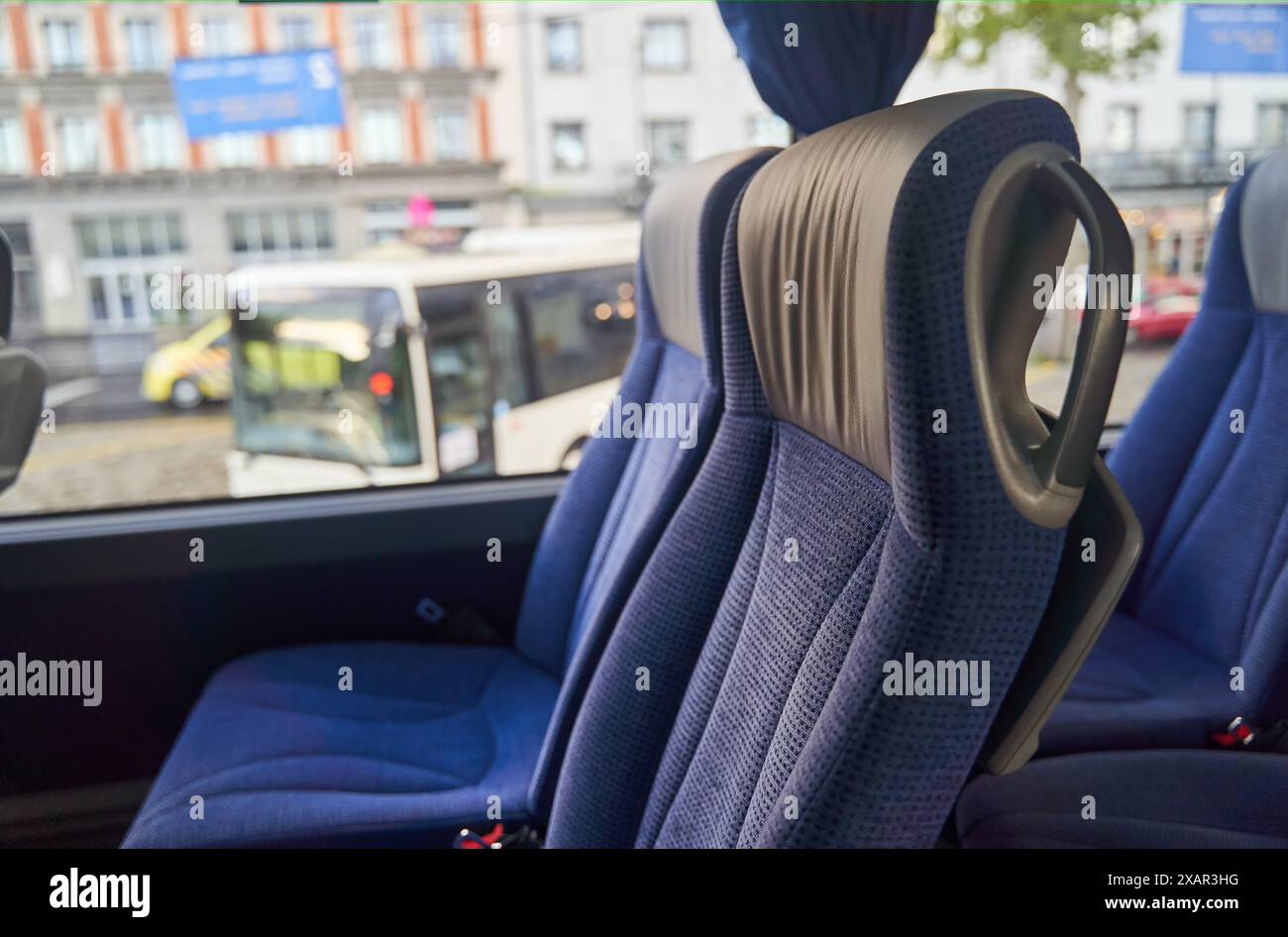 Blue bus seats and a view of the city from the window Stock Photo - Alamy