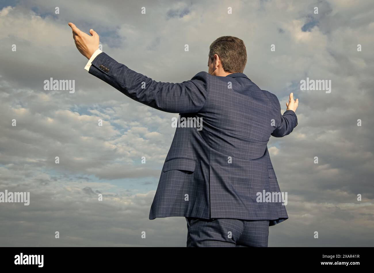 Professional man back view sky background. Man spreading arms wide open ...