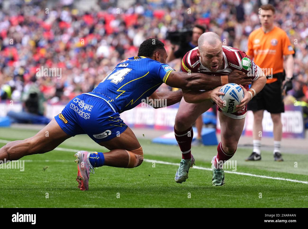 Wigan Warriors' Liam Marshall (right) is tackled by Warrington Wolves ...