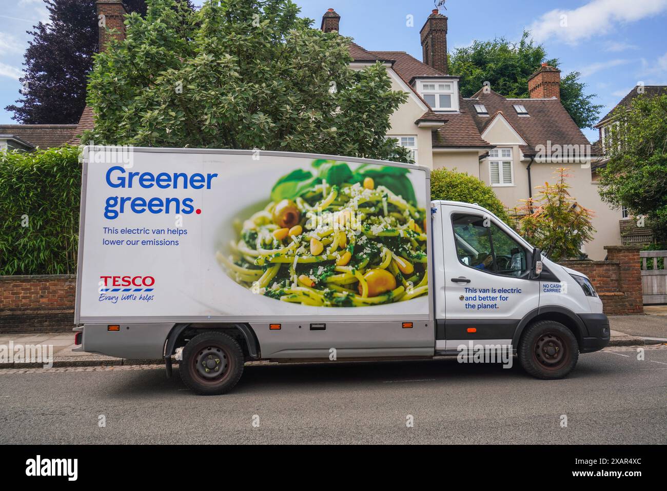 A Tesco electric grocery delivery van parked in a street in Wimbledon ...