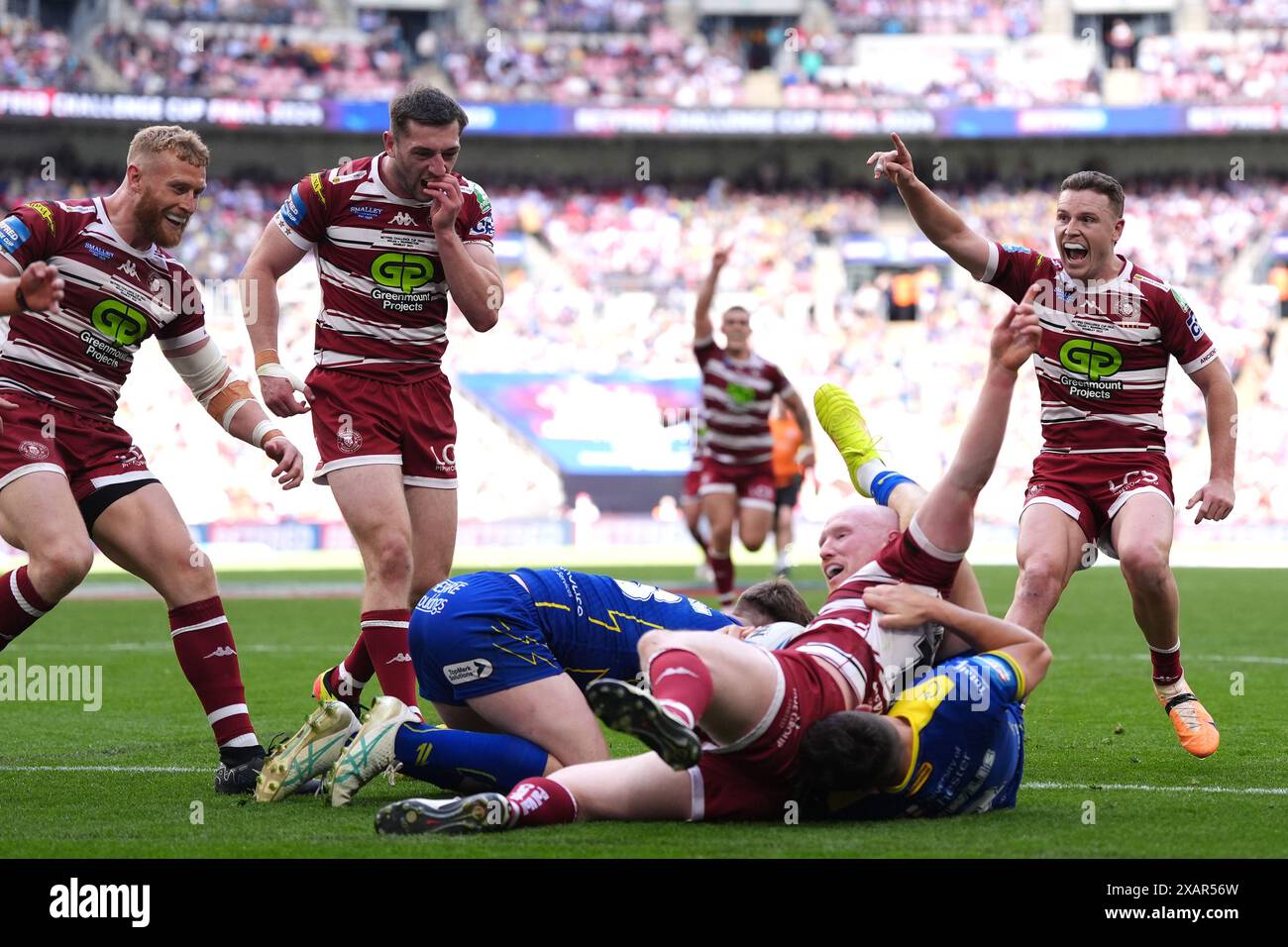 Wigan Warriors' Liam Farrell (centre) celebrates scoring his side's ...