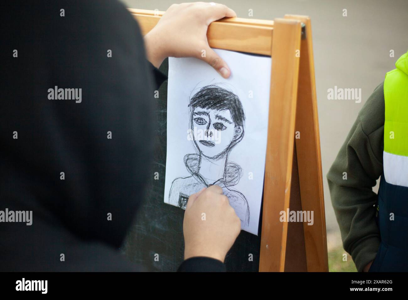 Artist draws. Person learns to draw. Details of drawing on easel ...