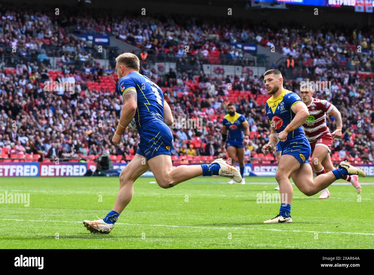 Matt Dufty of Warrington Wolves goes over for a try and makes the score ...