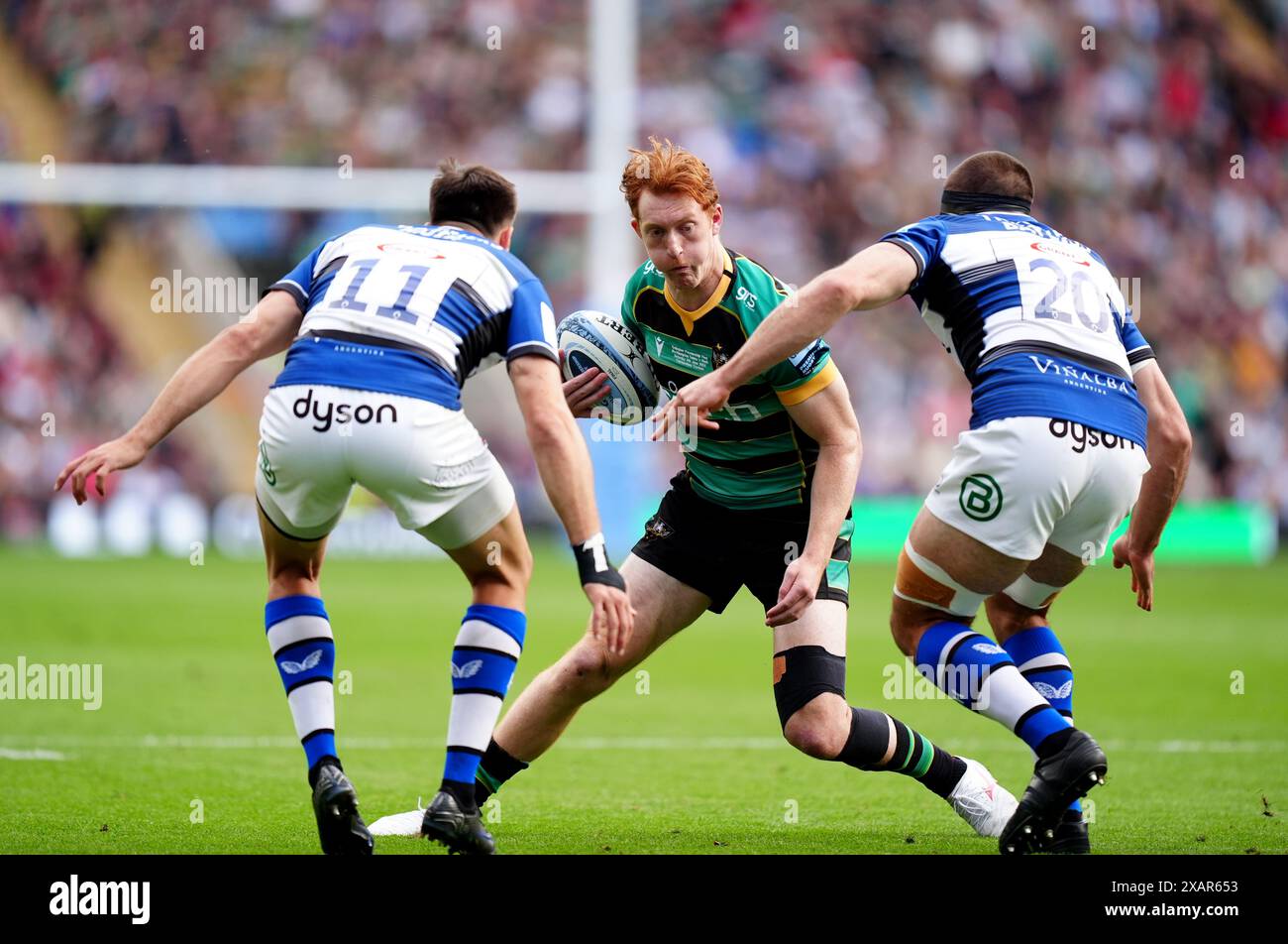 Northampton Saints' George Hendy (centre) is tackled by Bath Rugby's ...