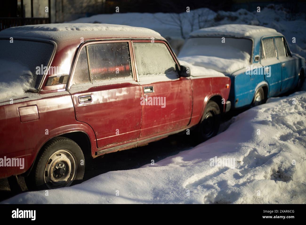 Old cars in the parking lot in winter. Russian cars. Transport in the ...