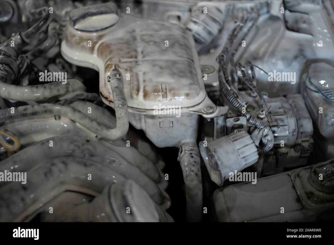 Car engine washing. DWigger in soap foam. Washing dirt off the machine ...