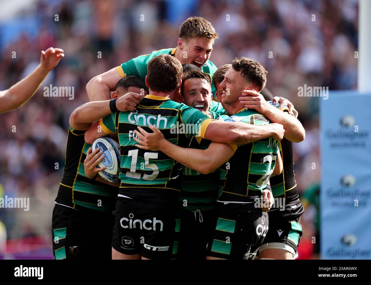 Northampton Saints' Alex Mitchell (centre rear) is mobbed by his team ...