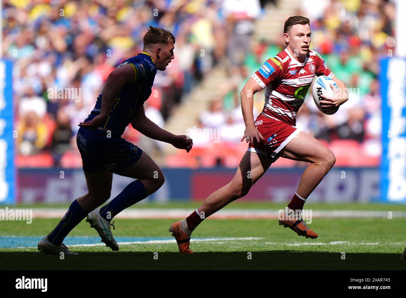 Wigan Warriors' Jai Field (right) escapes Warrington Wolves' Matty ...