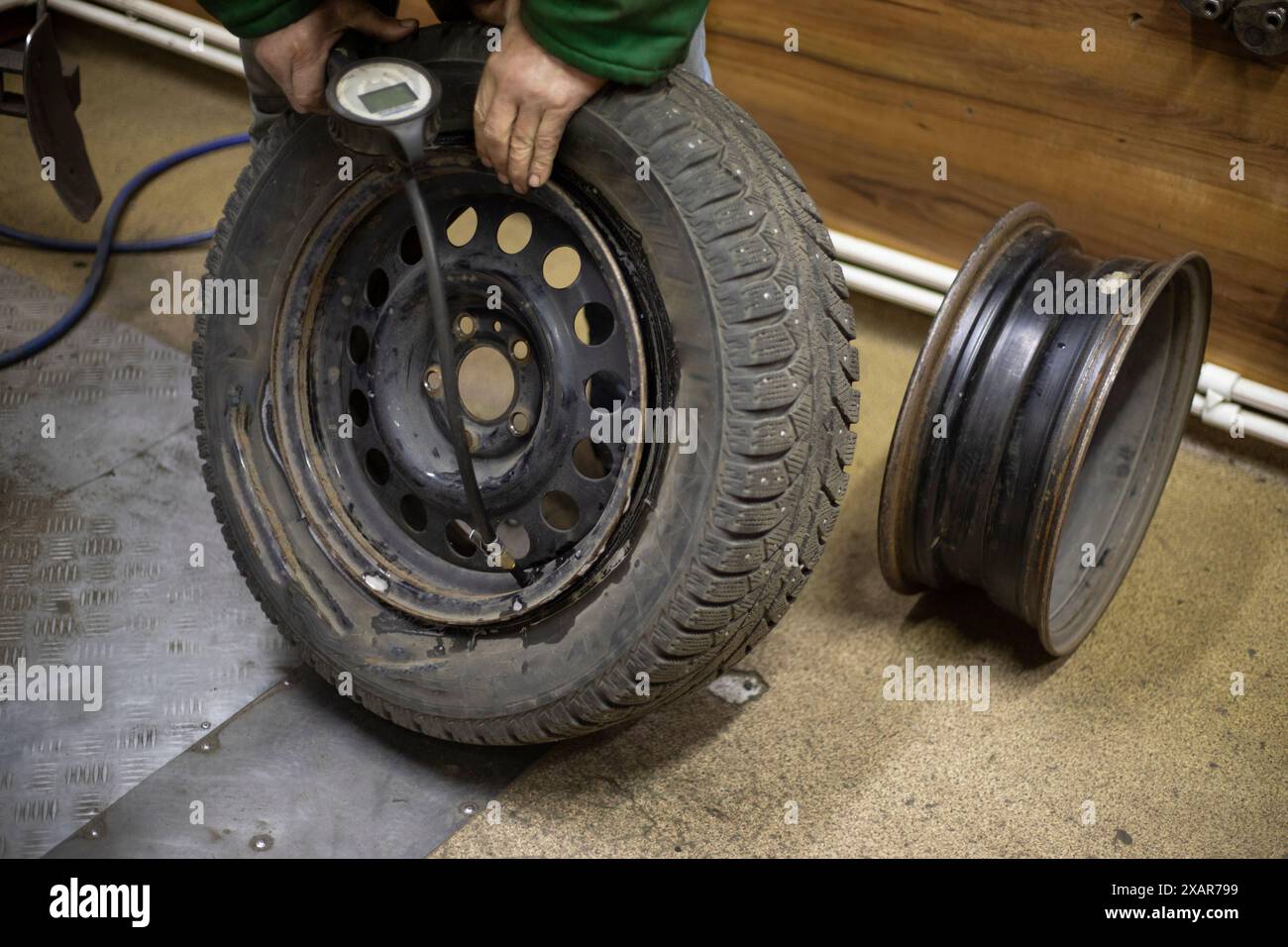 Tire fitting in a workshop. Wheel replacement. Removing the tire from ...