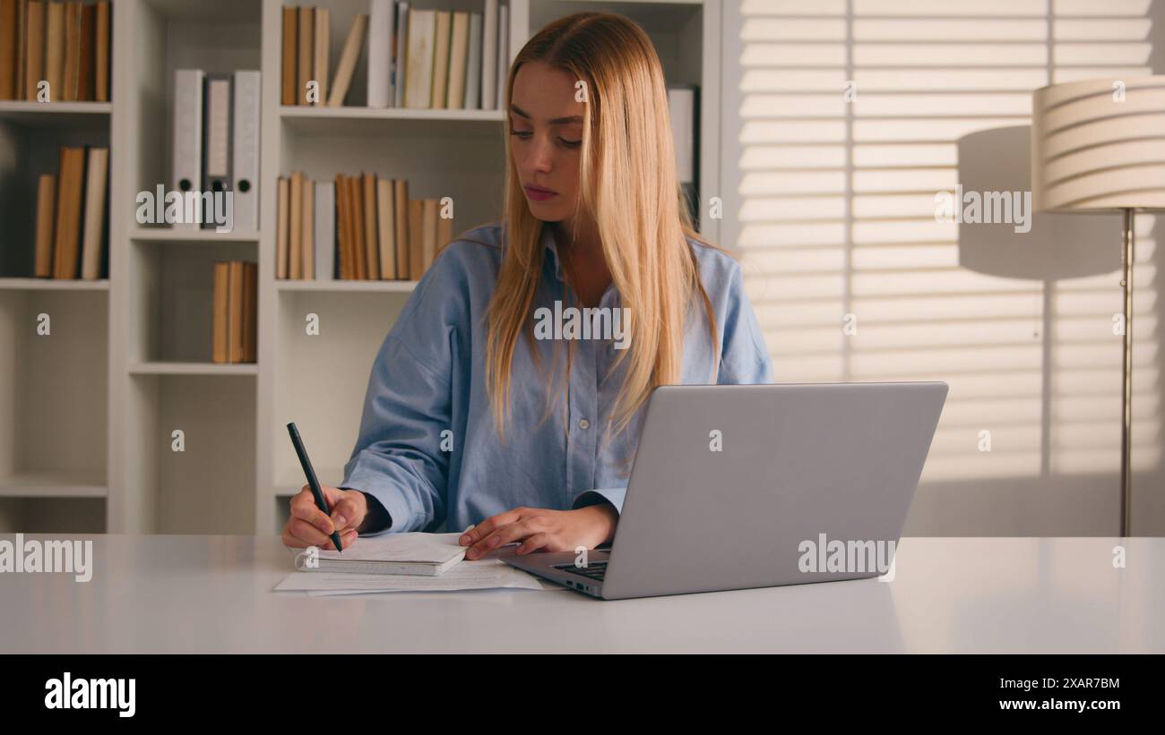 Caucasian female student author journalist at home office library learner woman businesswoman ...