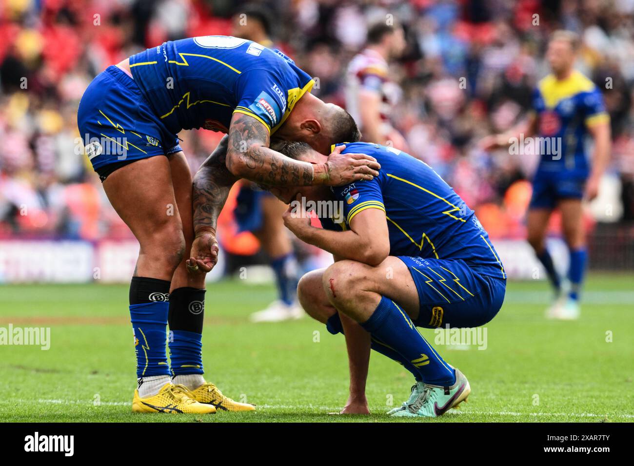 Paul Vaughan of Warrington Wolves consoles James Harrison of Warrington ...