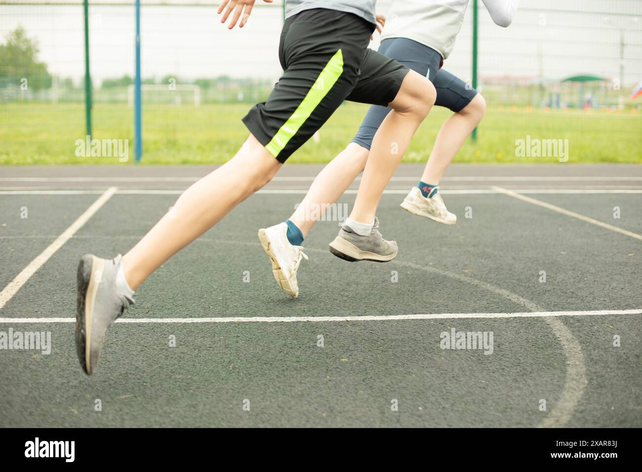 Movement of runner. Sports. Running warm-up. Guys train at stadium ...