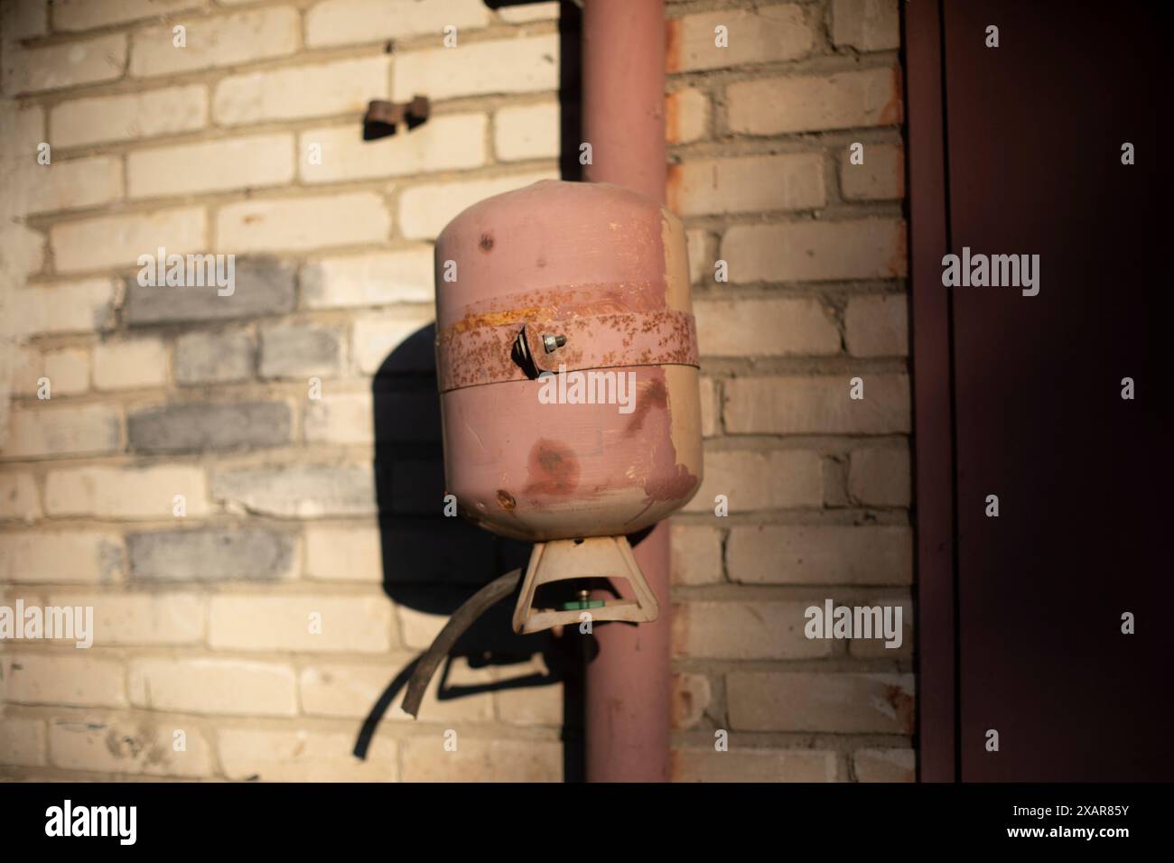 Gas cylinder. Gas barrel in the garage. Pipe on the wall. Details of ...