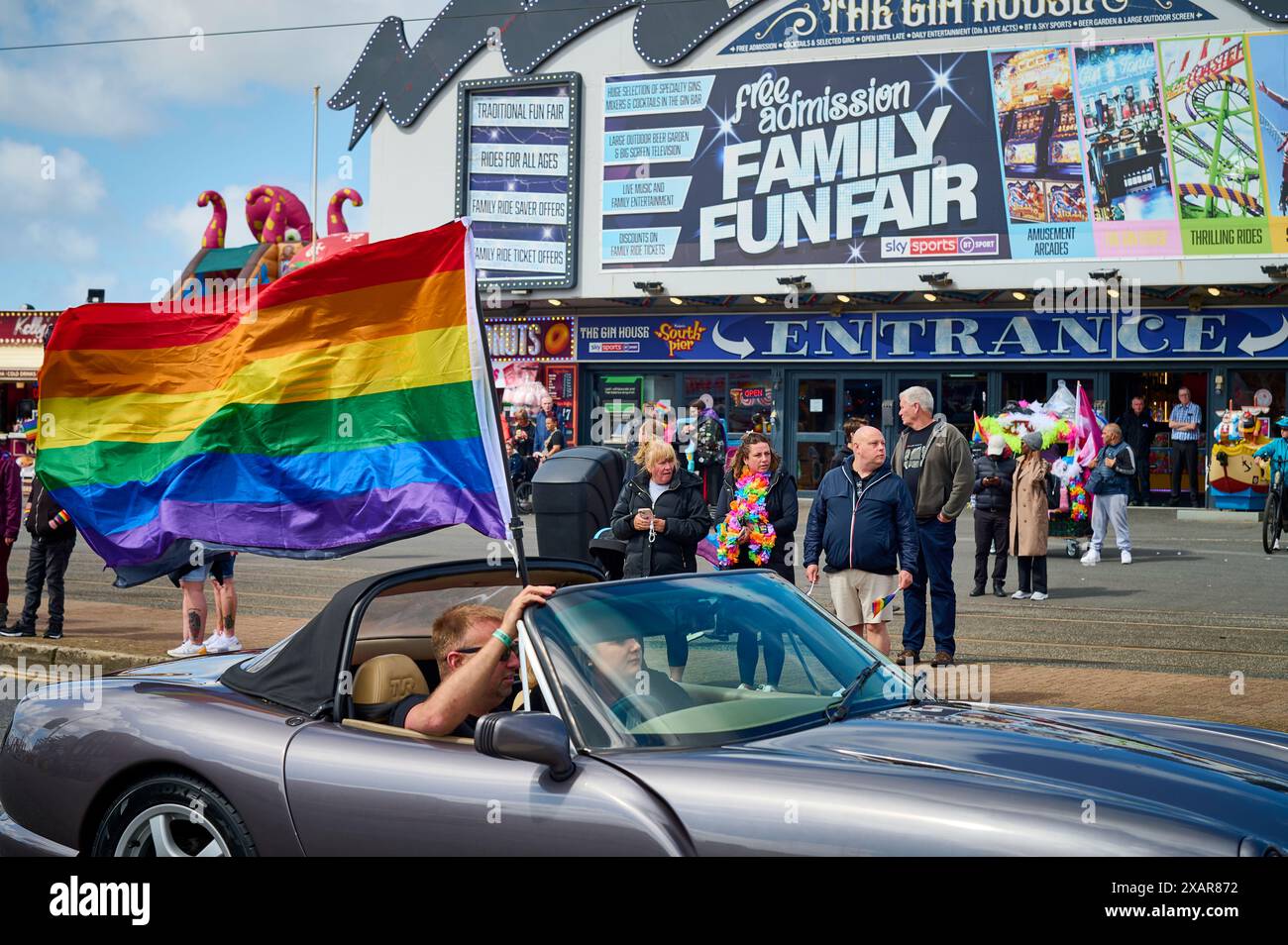 Pride parade along Blackpool Promenade 2024. Rainbow flag flying from a ...