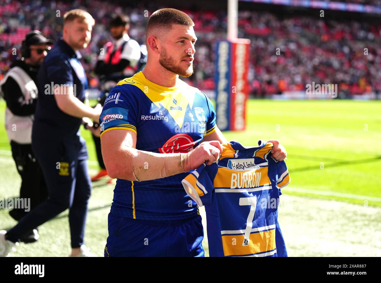 Warrington Wolves' Danny Walker holds up a shirt with the name of ...
