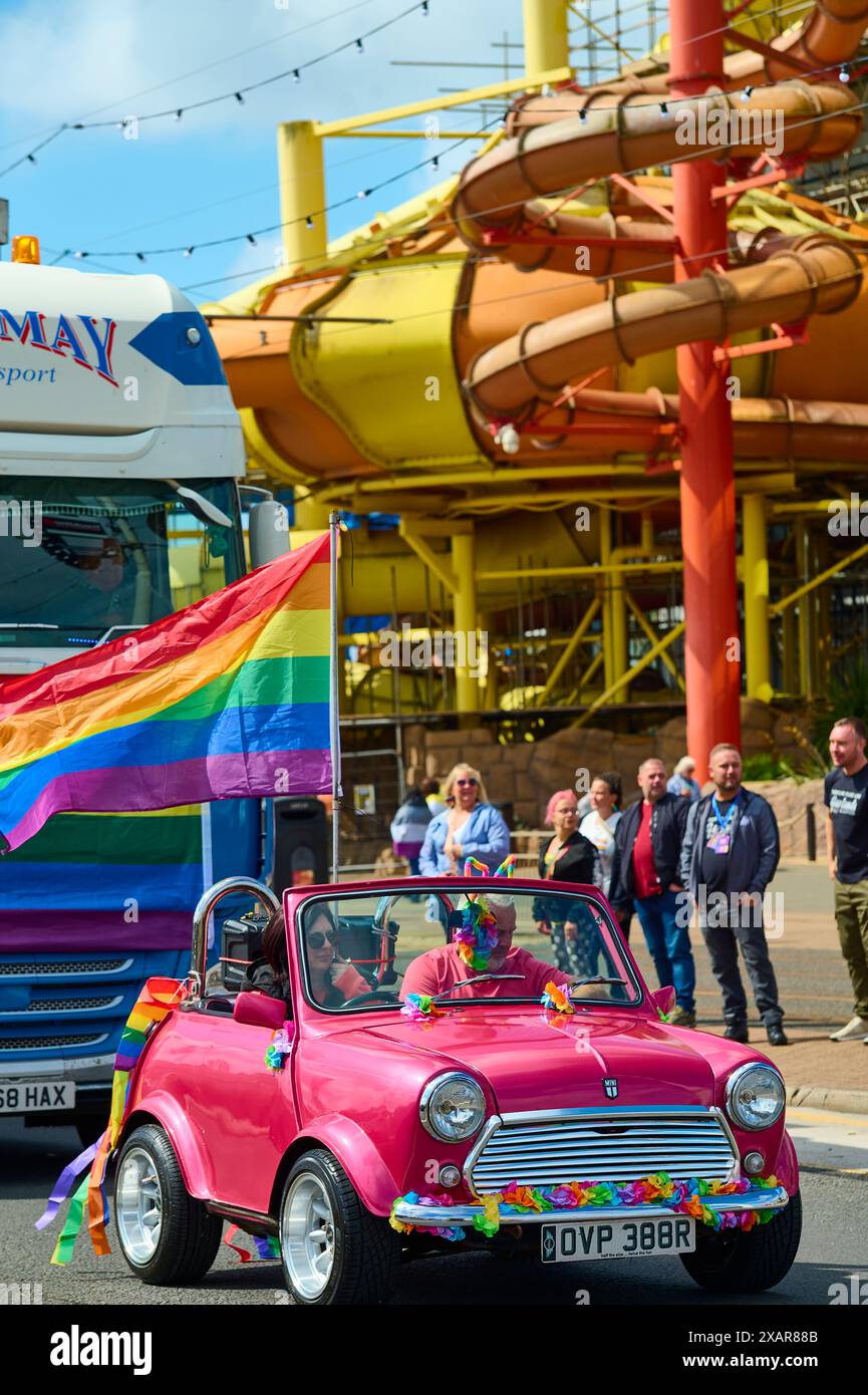Pride parade along Blackpool Promenade 2024. Miniature pink mini car ...