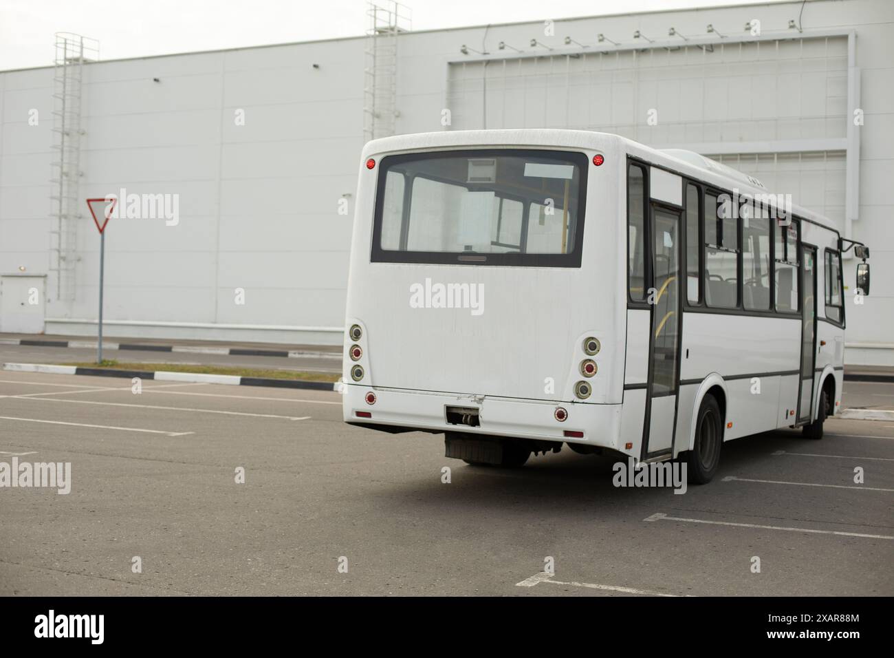 White bus in the parking lot of the shopping mall. Public transport ...