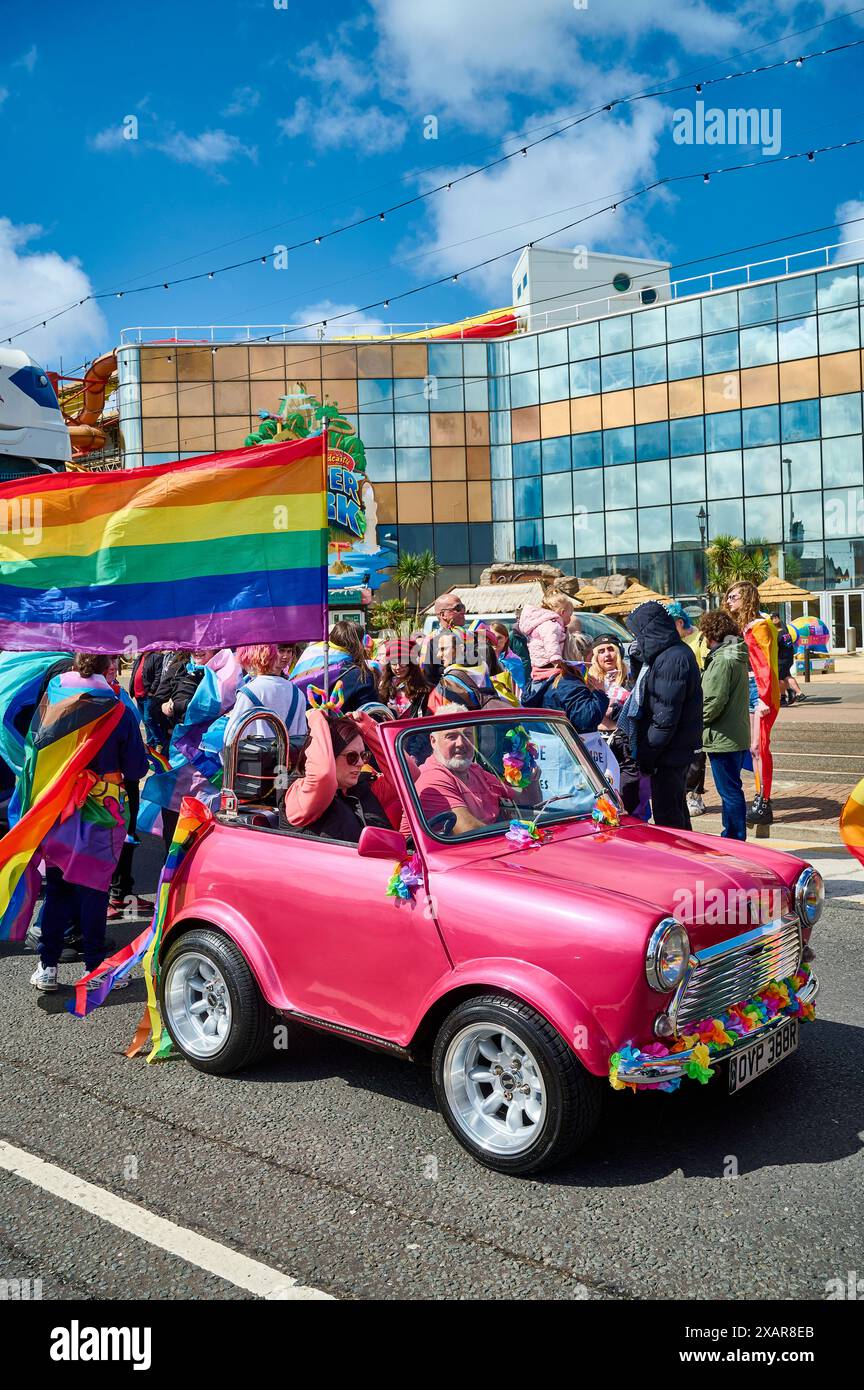 Pride parade along Blackpool Promenade 2024. Miniature pink mini car ...