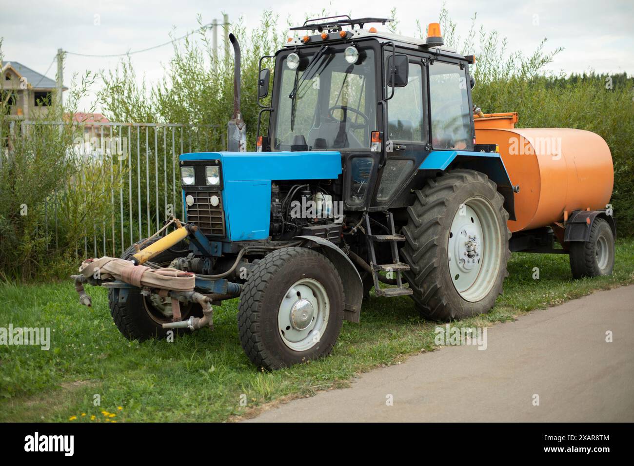Tractor with water. Tractor equipped with system water irrigation ...